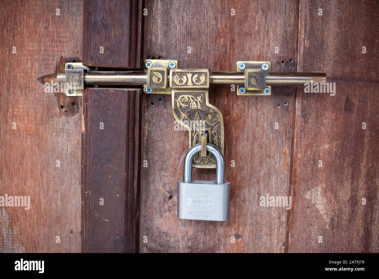 A close look at a classic, rusty and vintage metal padlock securing the ...