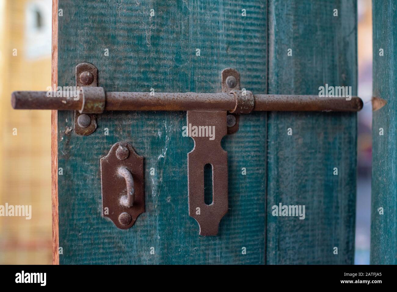 A close up photo of a brown vintage and rusty iron latch in the old ...