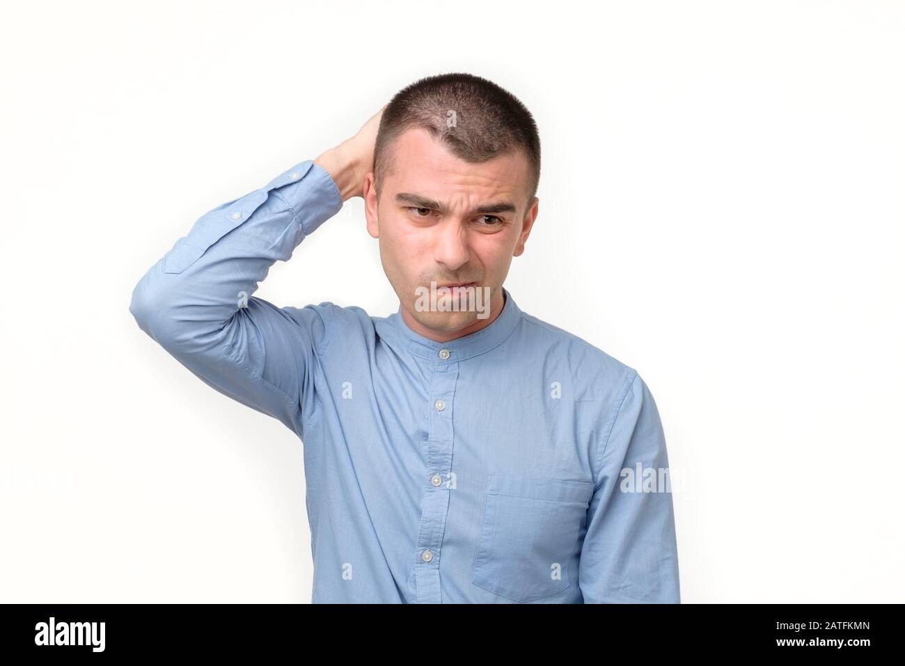 Hispanic young man thinking about idea or making a choice. Studio shot ...