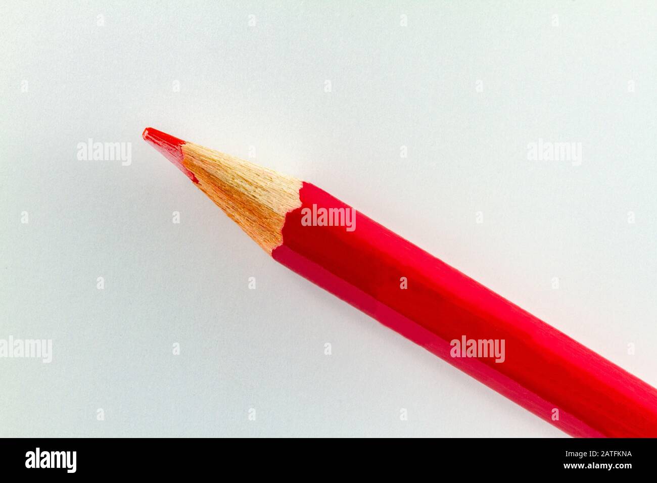 Red color pencil on white background color paper arranged diagonally ...