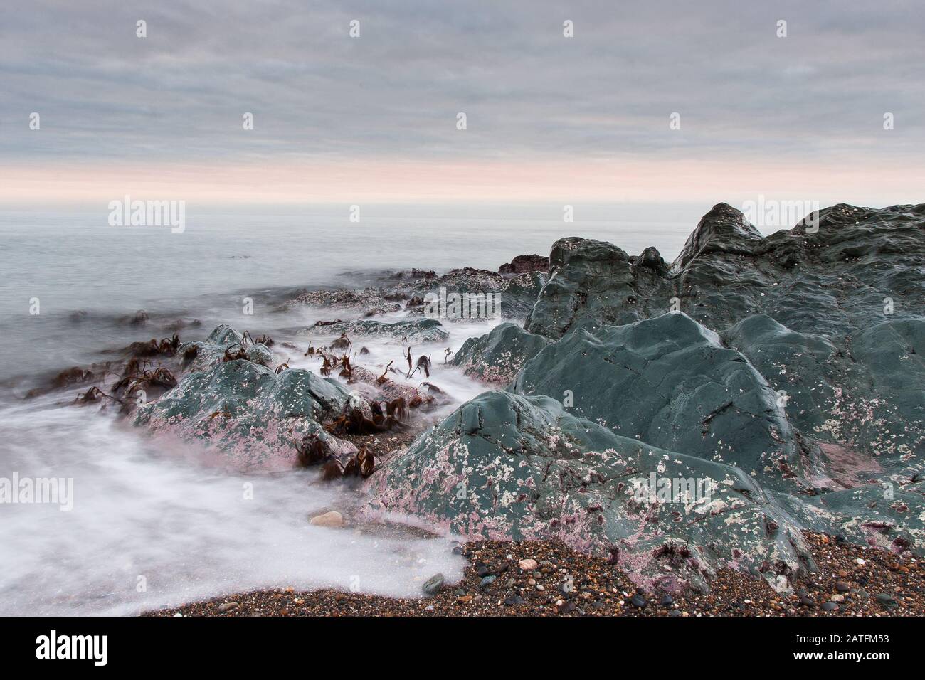 A beautiful scenery of wave splashing at the sunrise Stock Photo - Alamy