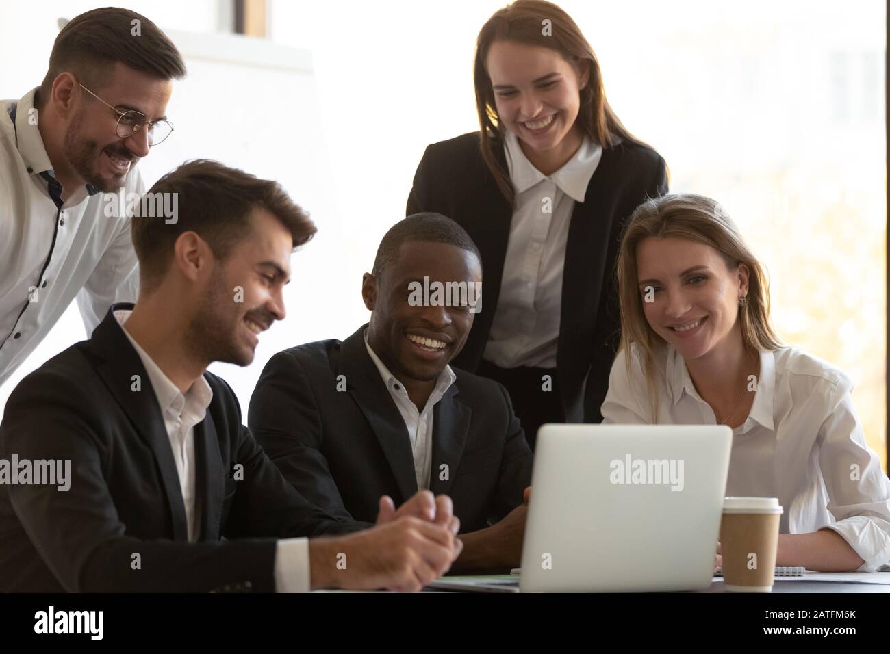 African staff member and colleagues working together using online ...