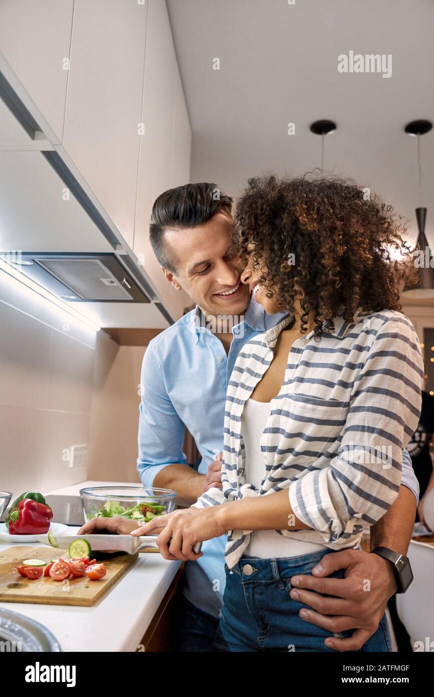 Happy diverse couple cooking together hi-res stock photography and ...