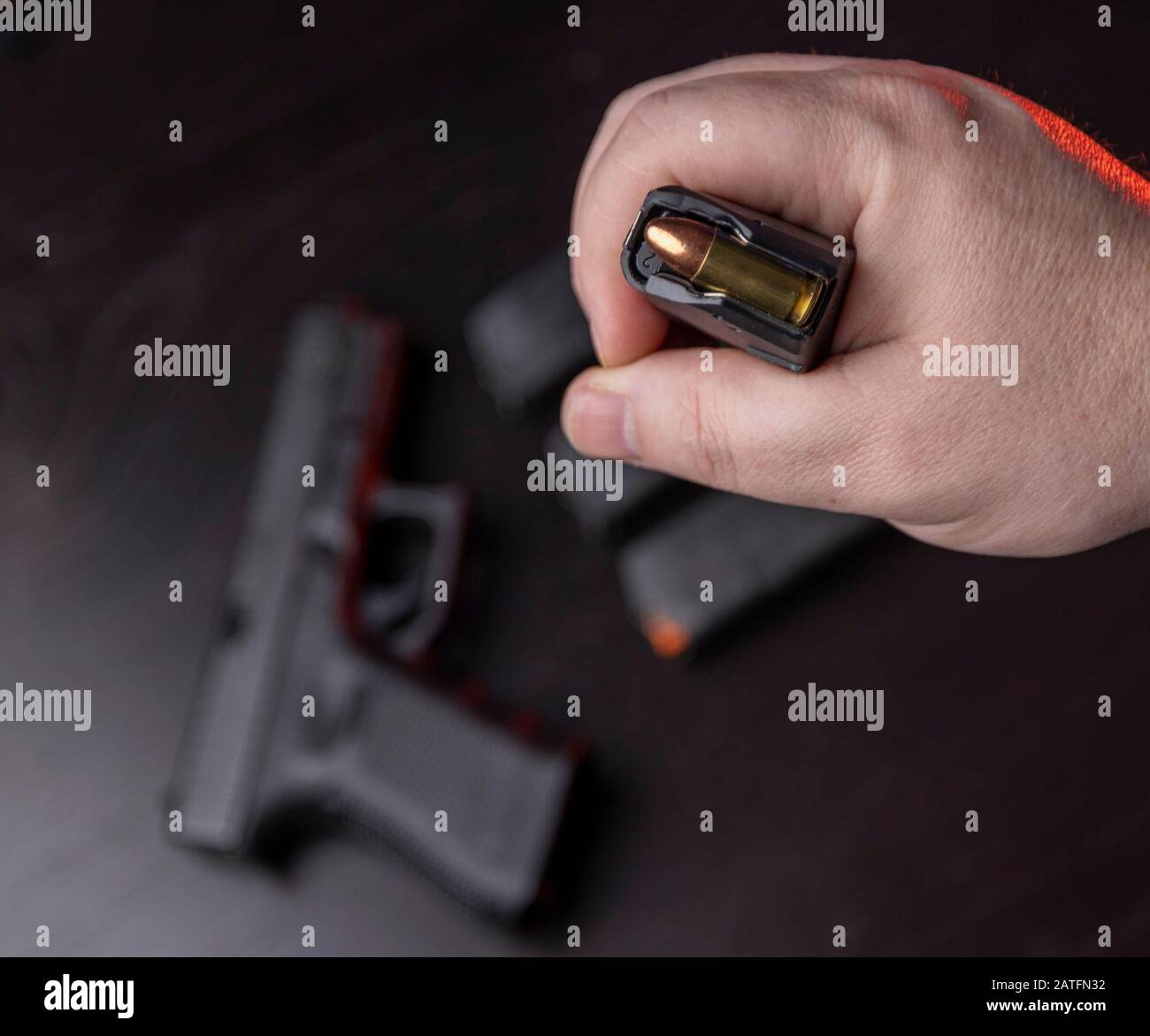 Reloading 9mm with gun in background Stock Photo - Alamy