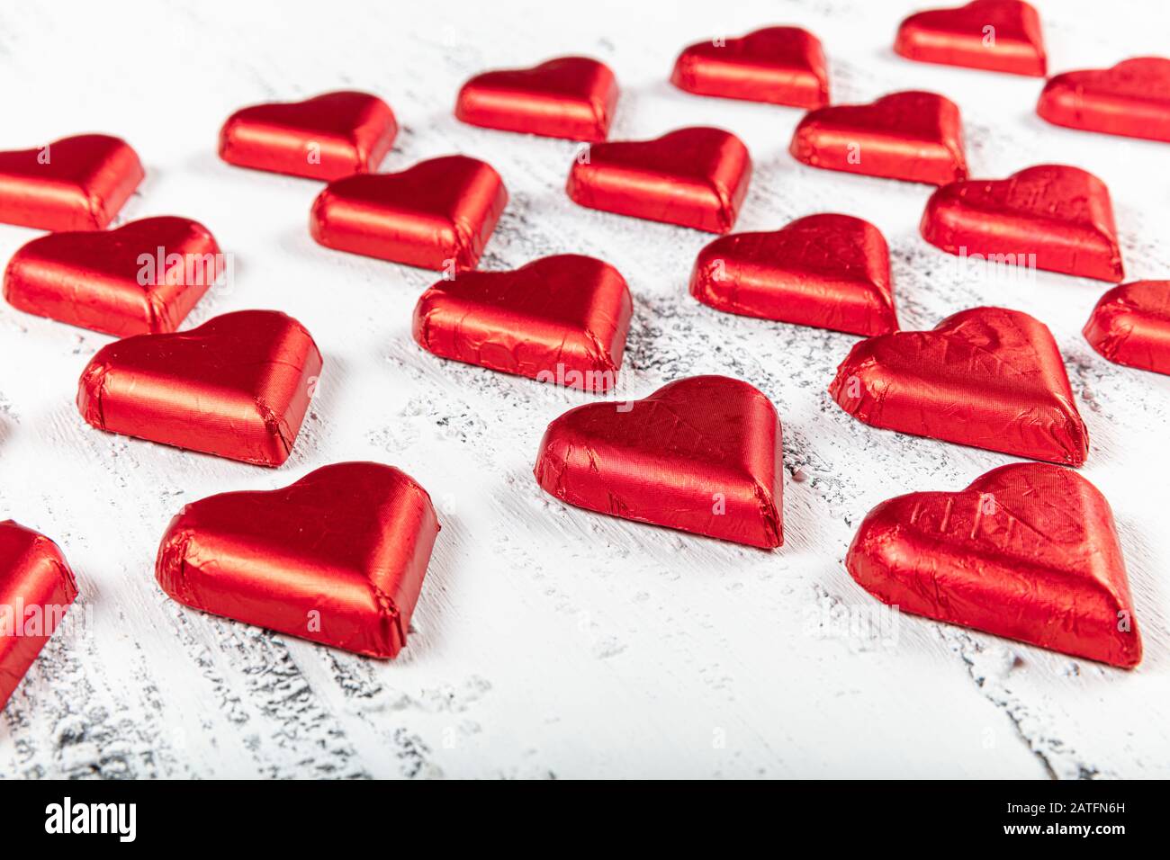 Heart shaped chocolate candies wrapped in red colorful foil for ...