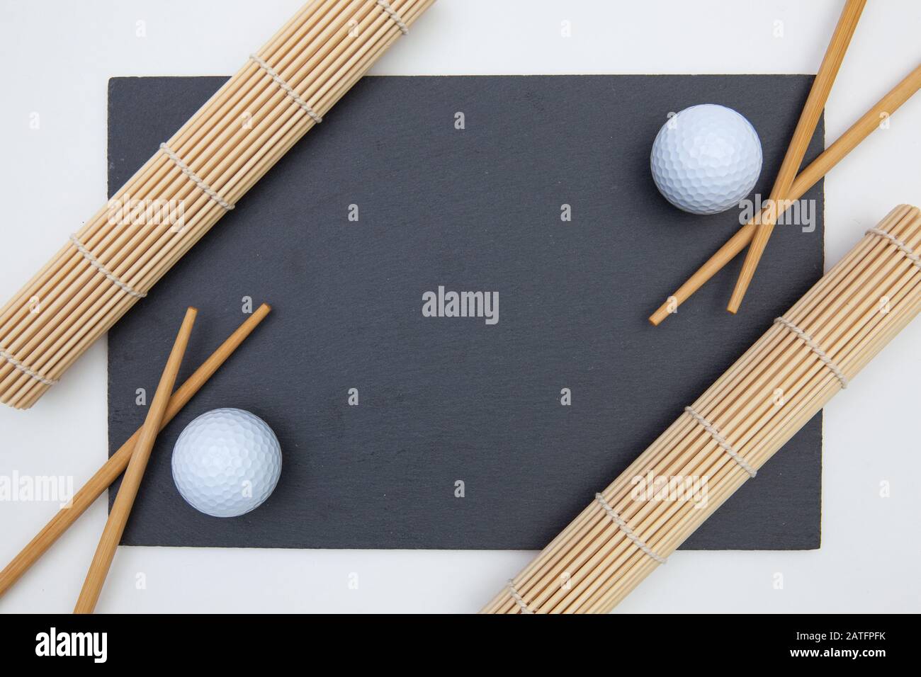 Rectangular slate plate with chopsticks for sushi and golf ball. Golf ...
