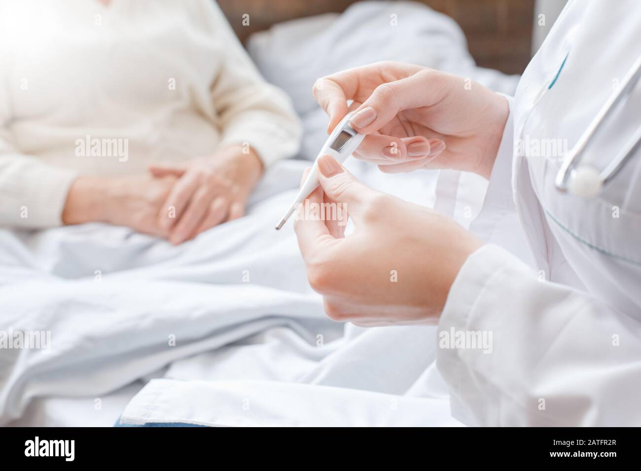 Nurse taking female patient temperature hi-res stock photography and images - Alamy