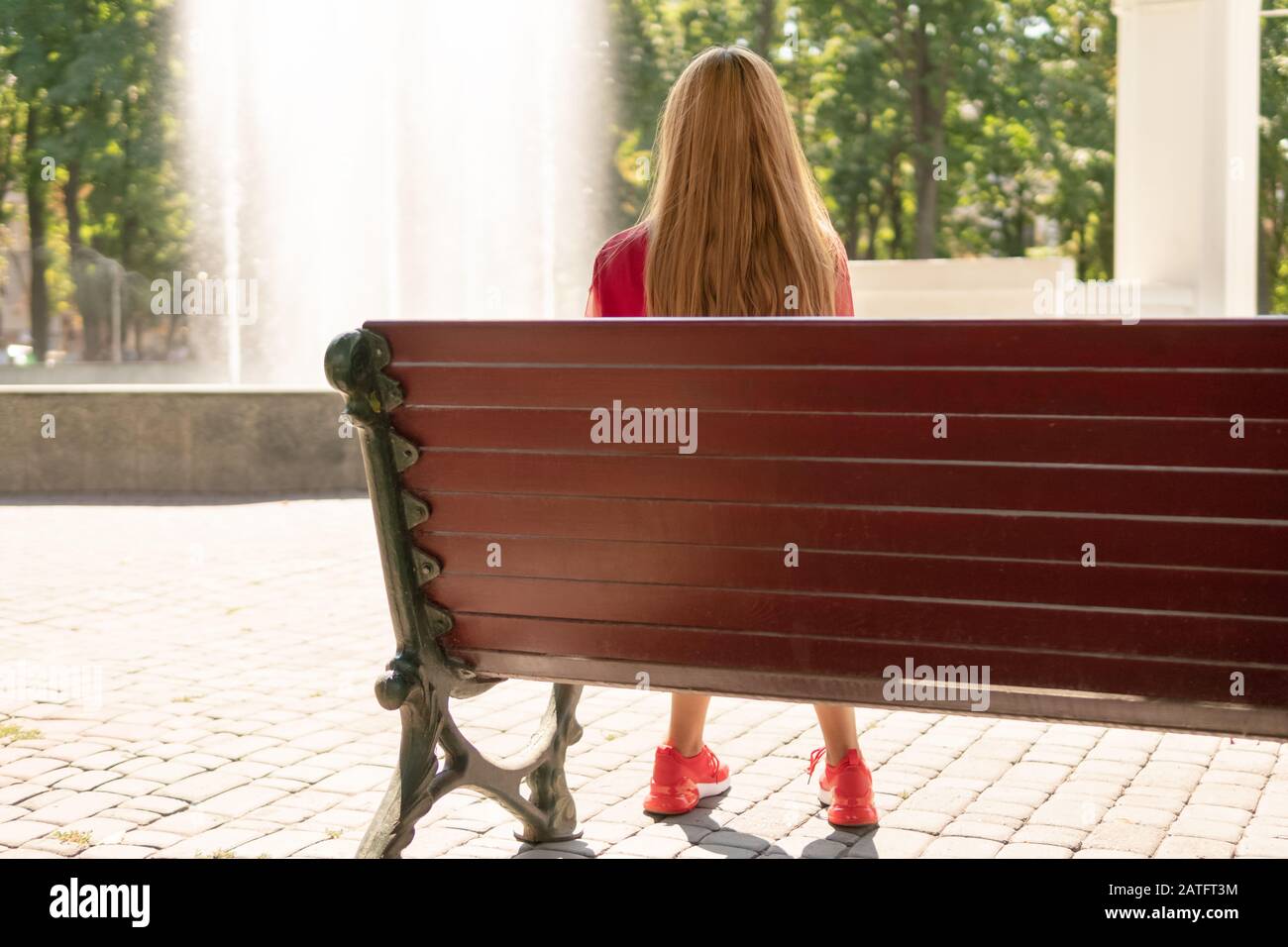 Blonde girl on park bench hi-res stock photography and images - Alamy
