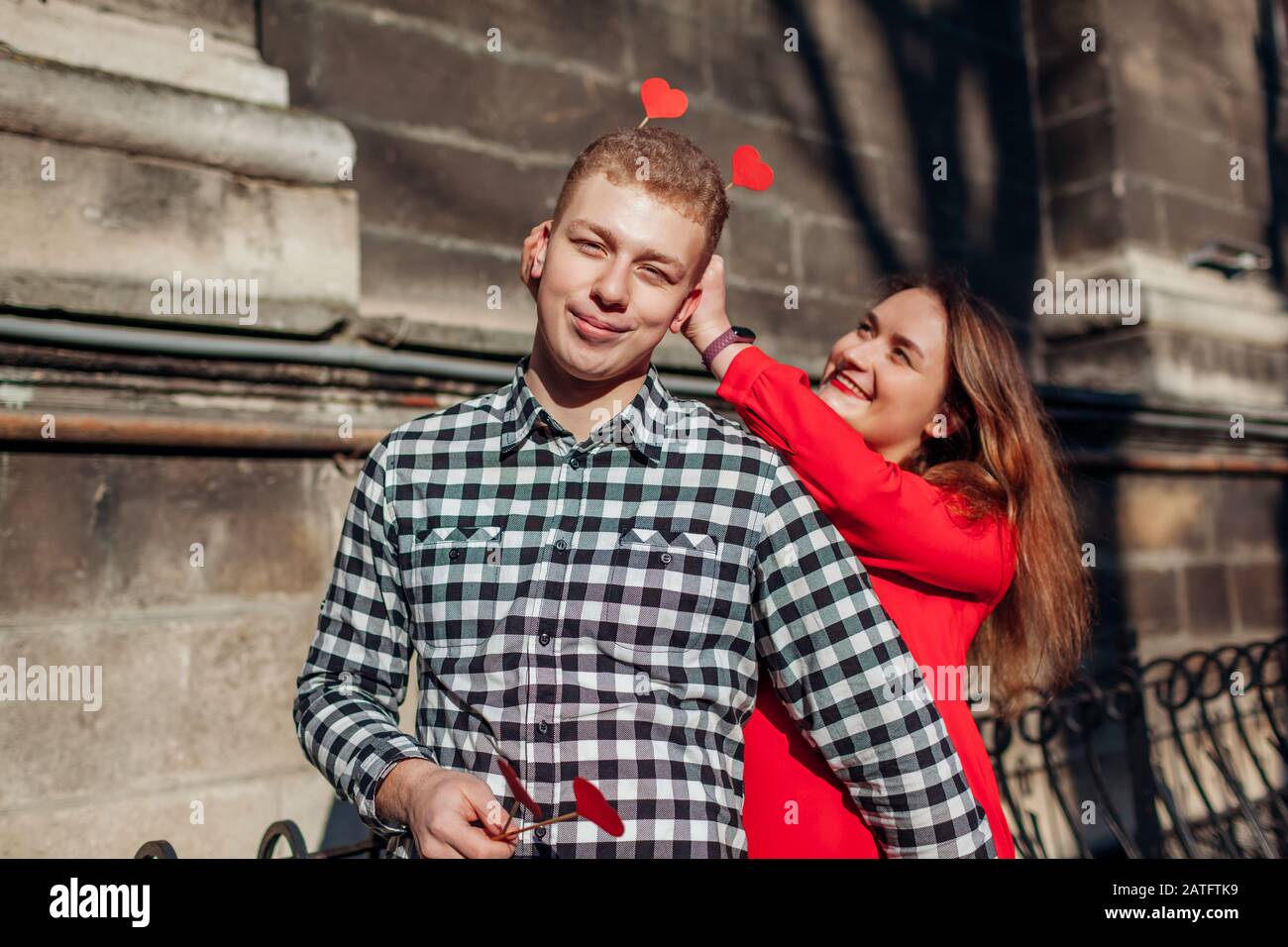 Valentines day photo booth props. Woman hiding heart shaped props in ...