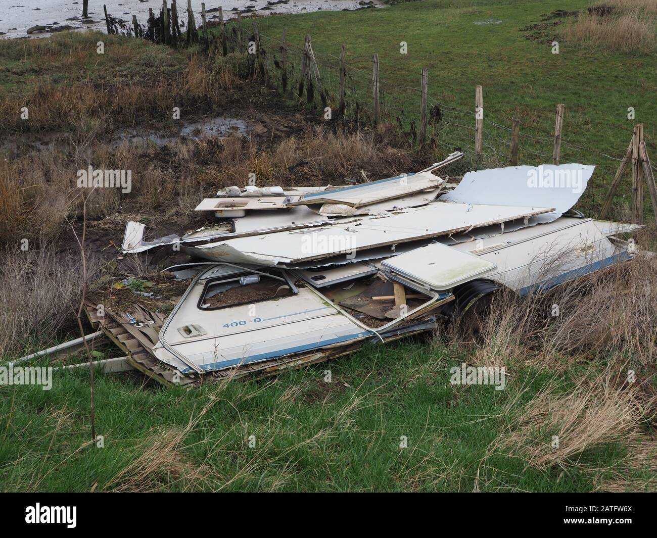 An abandoned / derelict / fly-tipped caravan on the banks of the Swale ...