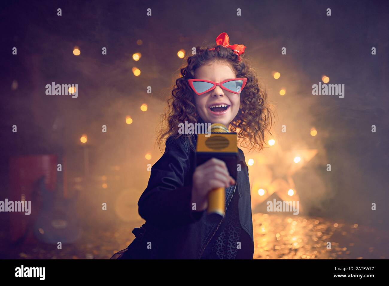 little beautiful girl with curly hair singing in recording studio Stock ...