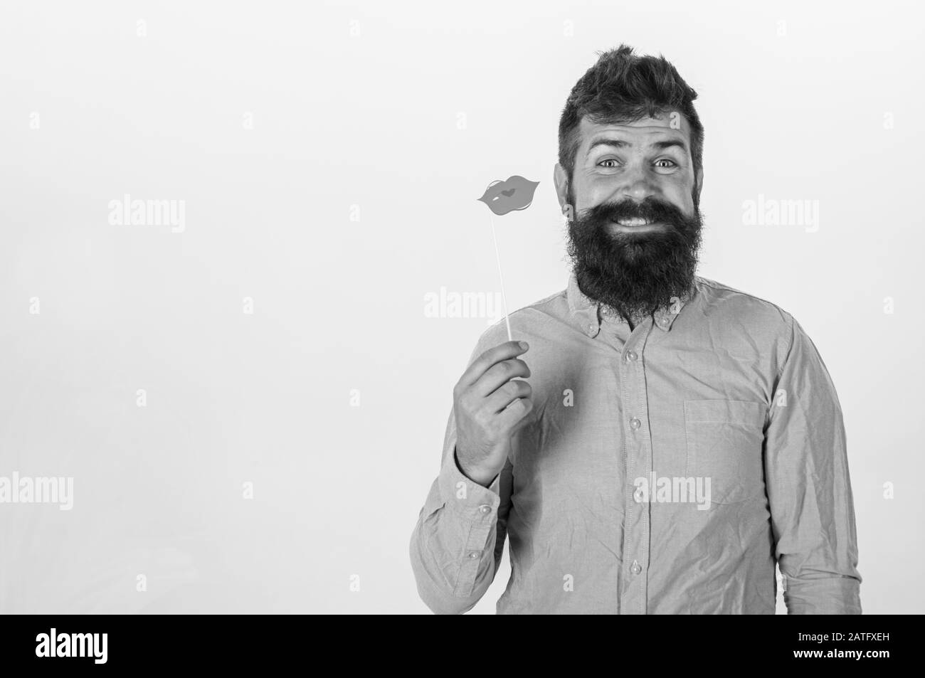 Photo booth fun concept. Man holding paper party props lips, white ...