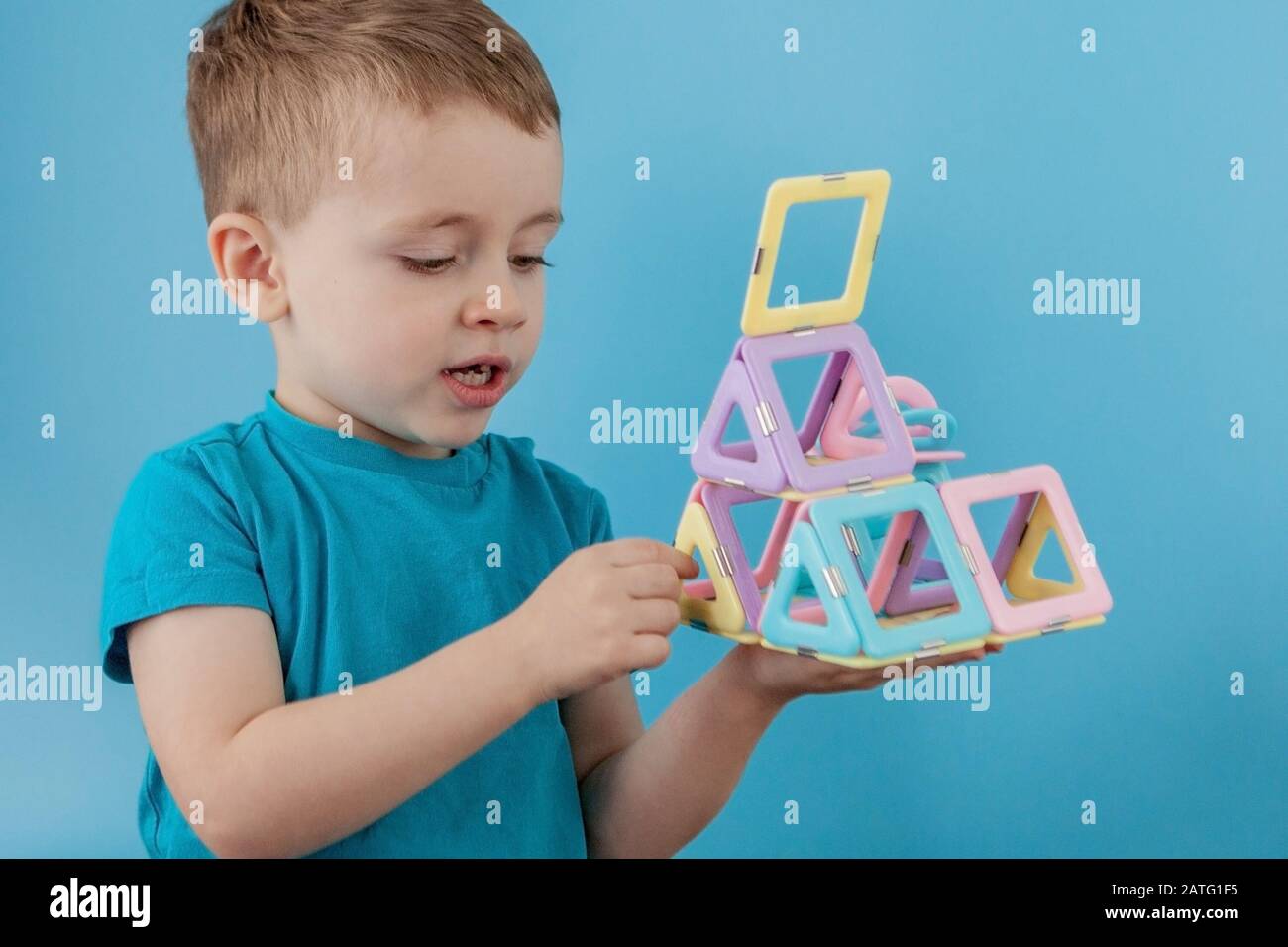 Boy looks through the shape in the color constructor with the ...
