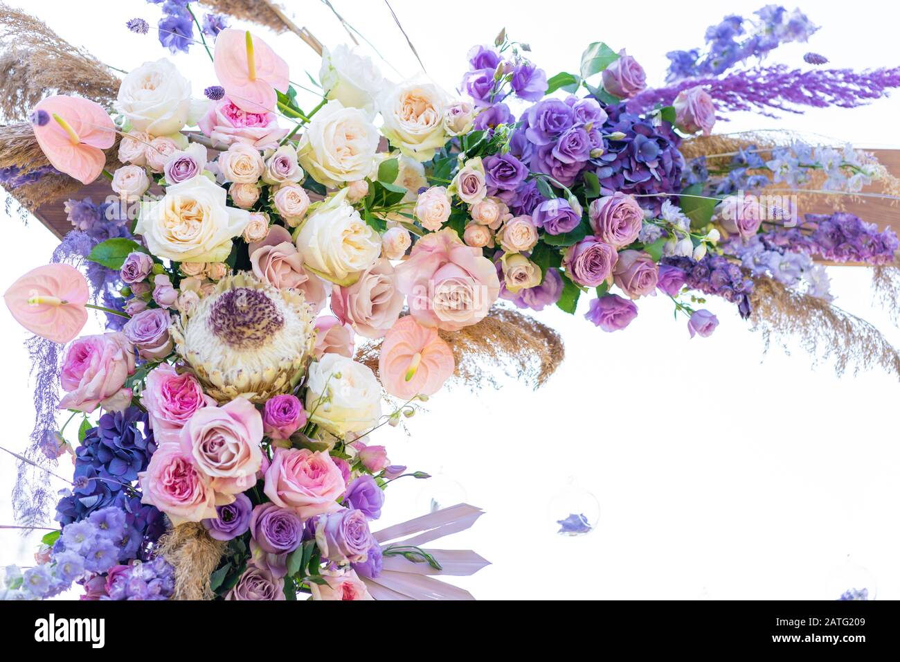 Decorative decoration of the wedding arch with fresh flowers. Holding a ...