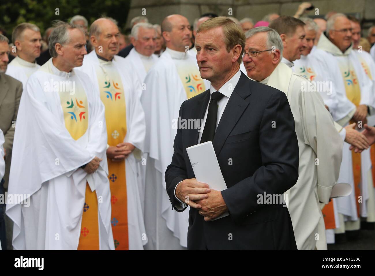 Current Irish Prime Minister Taoiseach Enda Kenny follows the coffin of ...