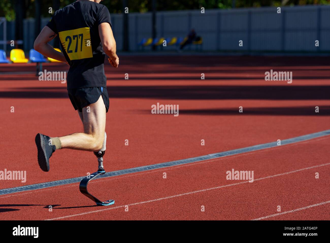 Athlete running with a prosthetic leg at a stadium Stock Photo - Alamy