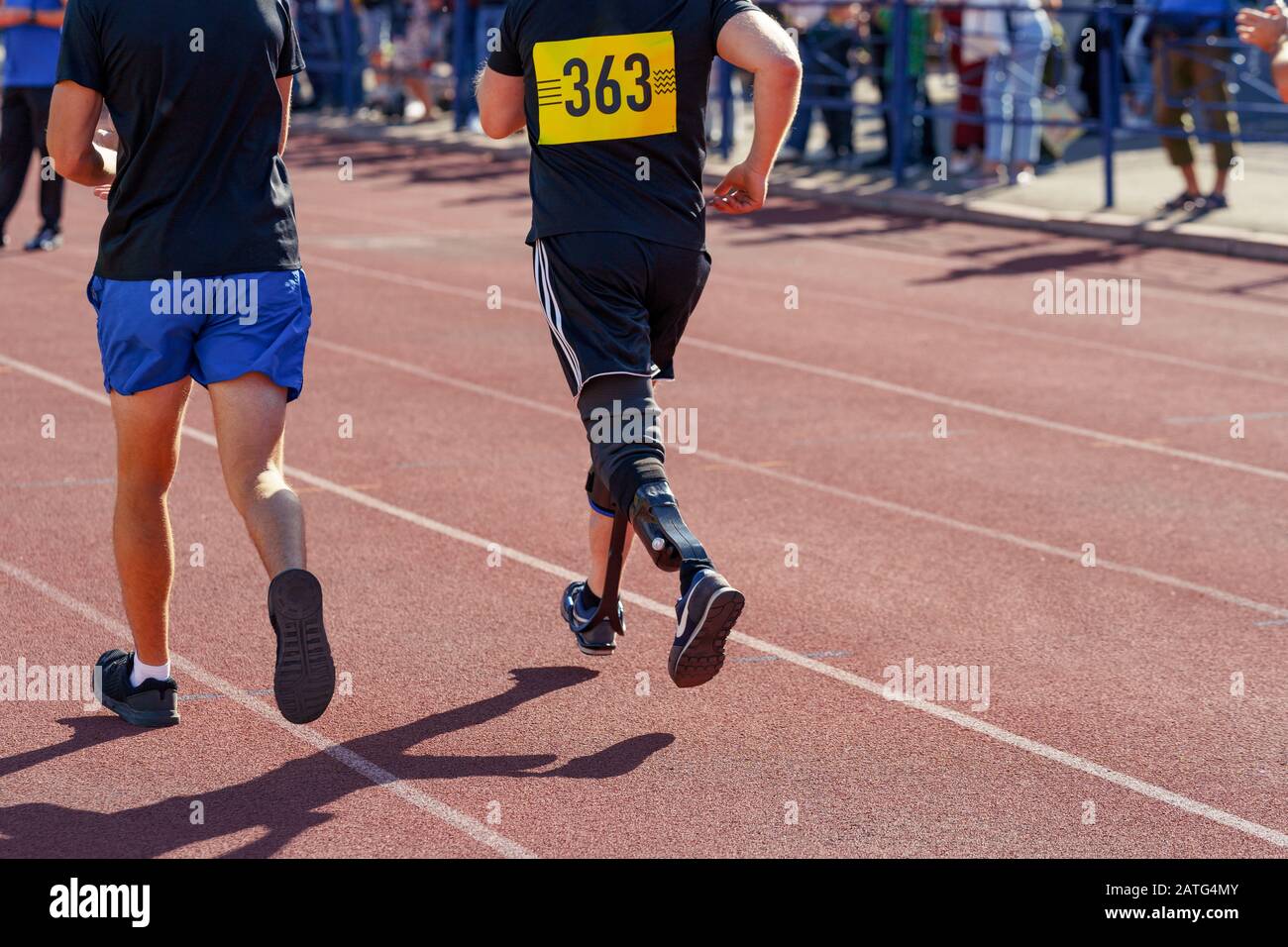 Athletes running a race on a track at the stadium Stock Photo - Alamy