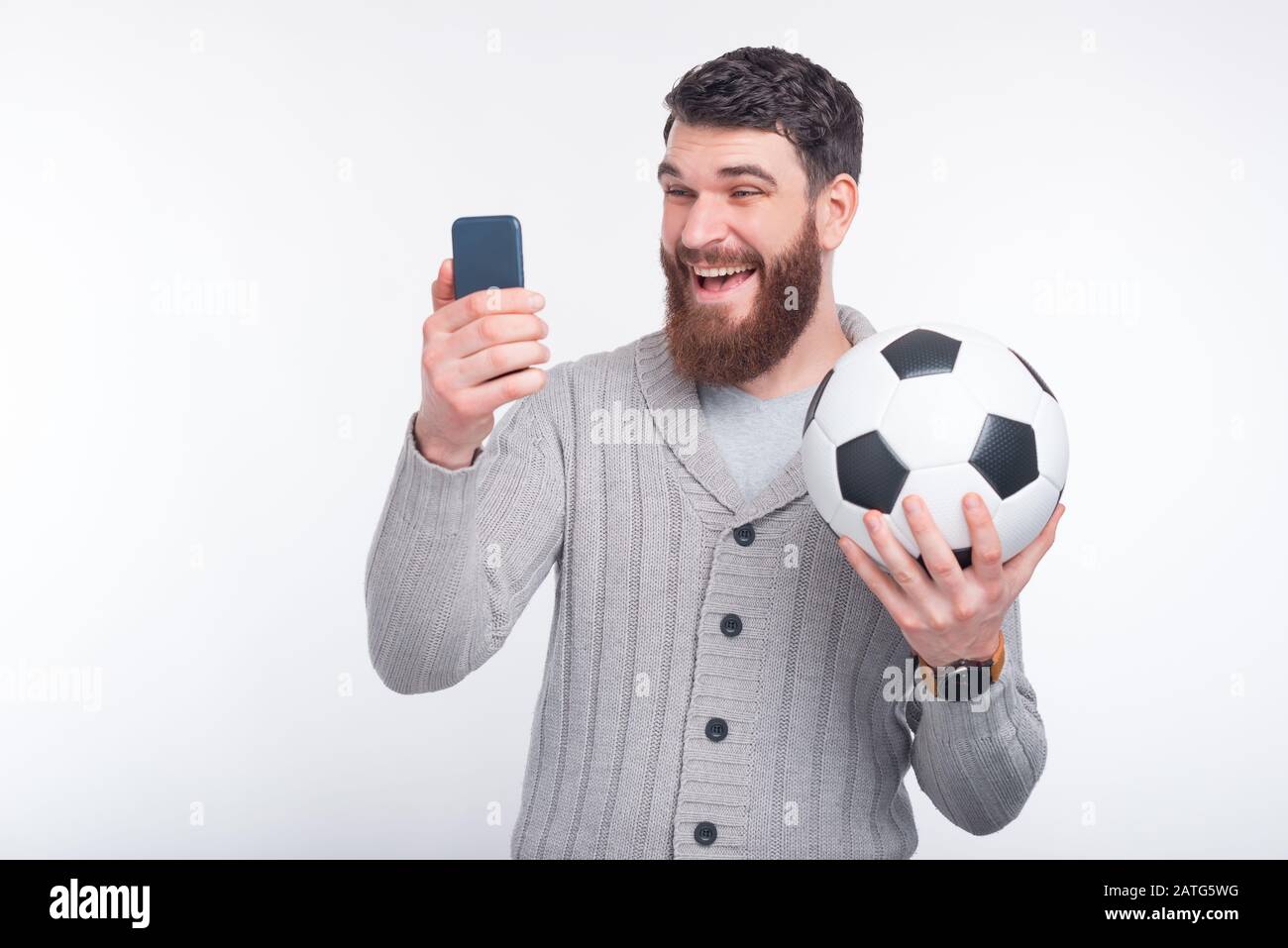 Mobile phone football shirt hi-res stock photography and images - Alamy
