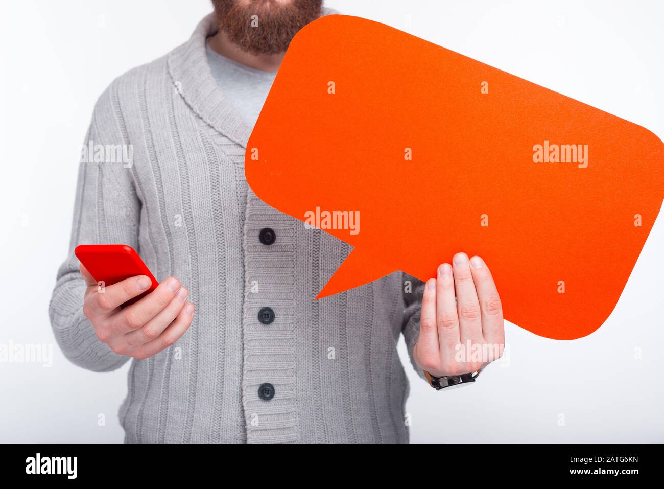Catch the message. Faceless man holds his red phone and a bubble speech ...