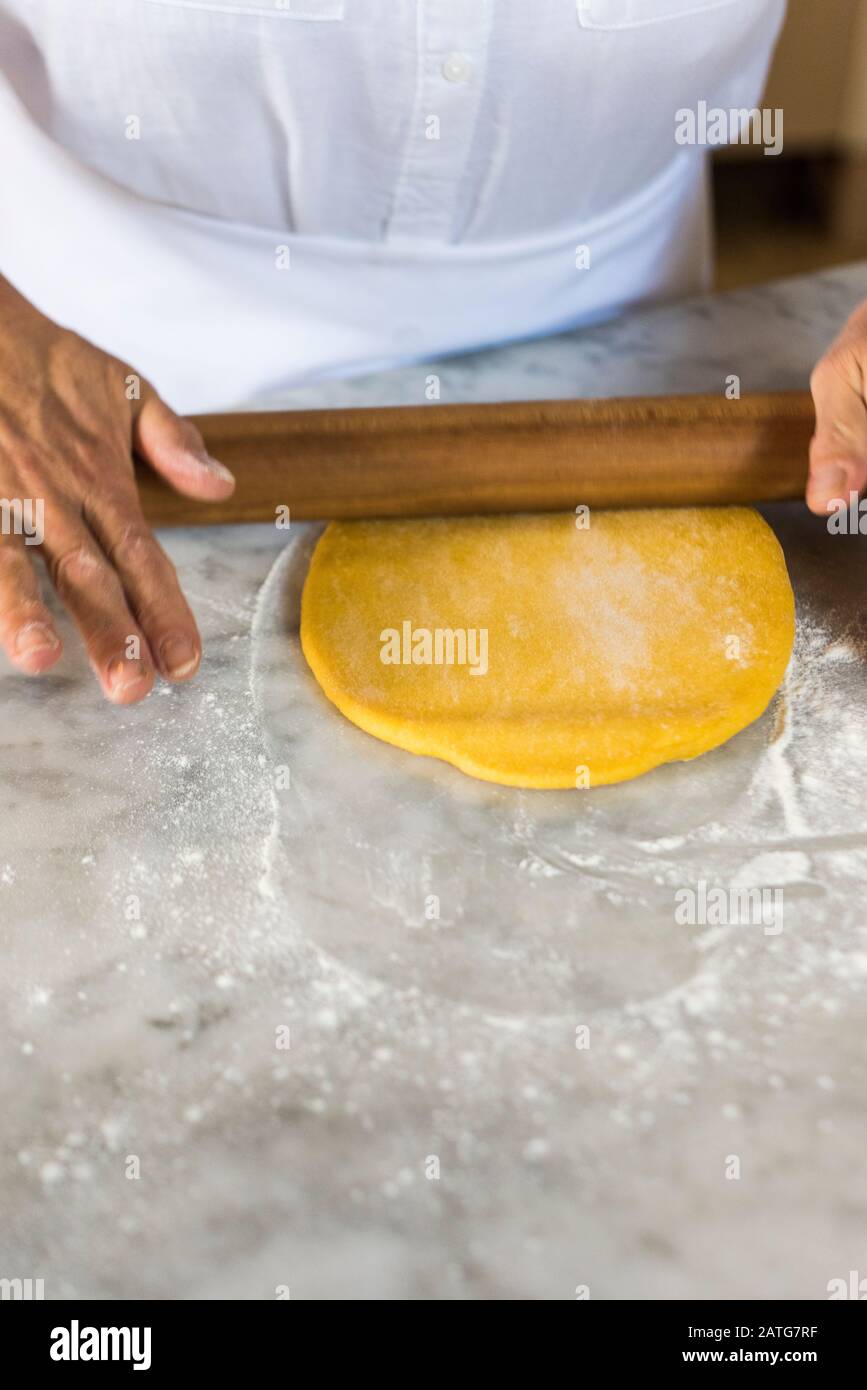 Hands rolling pasta hi-res stock photography and images - Alamy