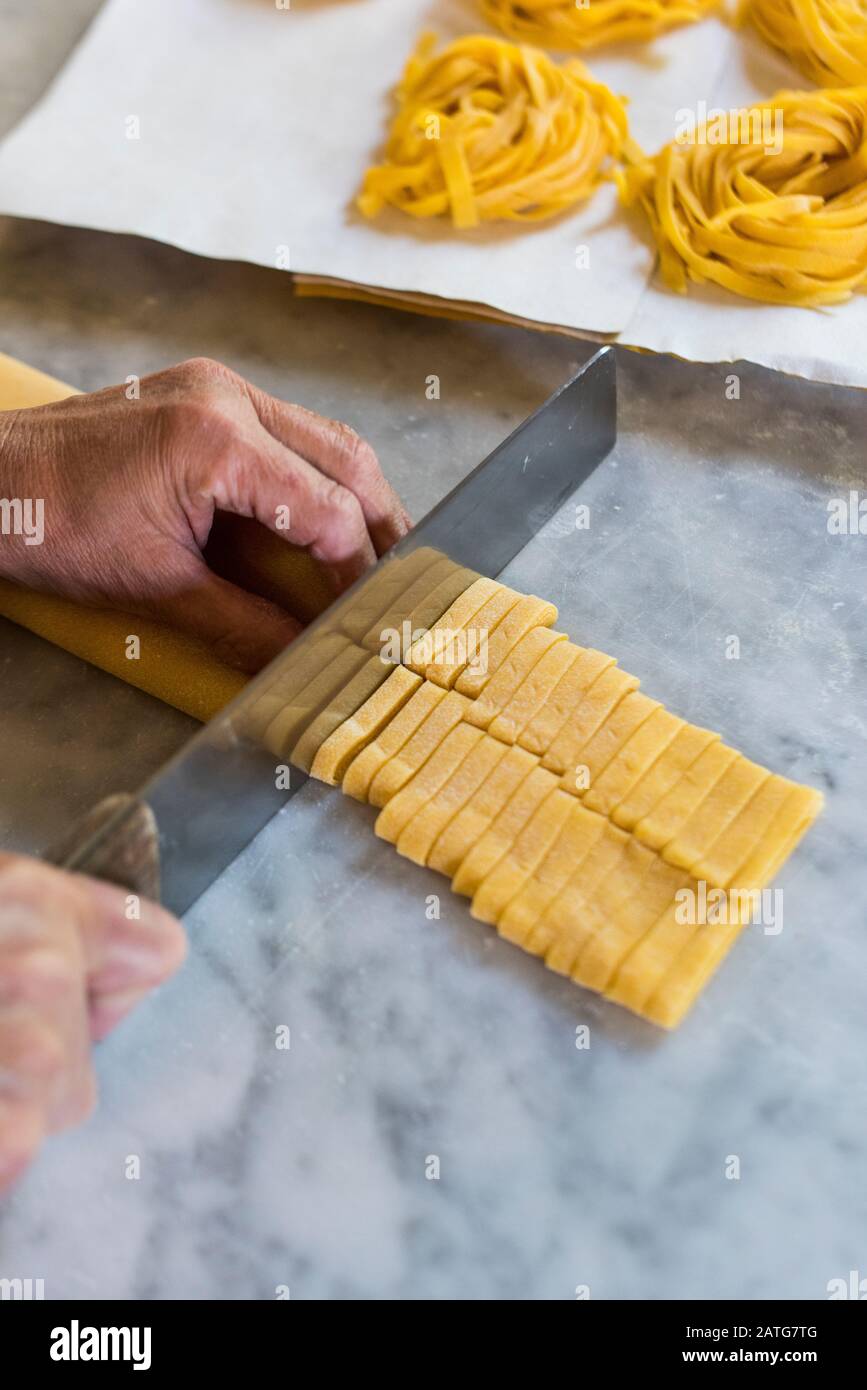 Italian woman making homemade Tagliatelle pasta Stock Photo - Alamy