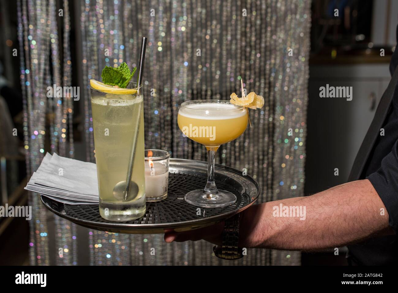 Server holding tray of fancy cocktails Stock Photo - Alamy