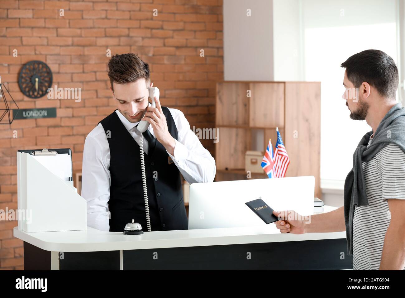 Male receptionist on the phone hi-res stock photography and images - Alamy
