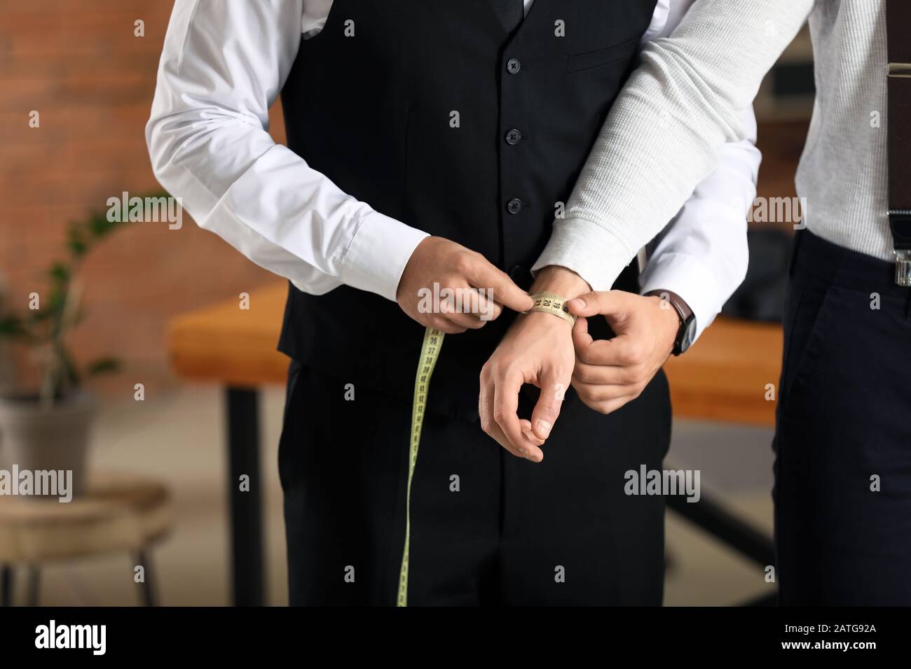 Male tailor taking measurements hi-res stock photography and images - Alamy