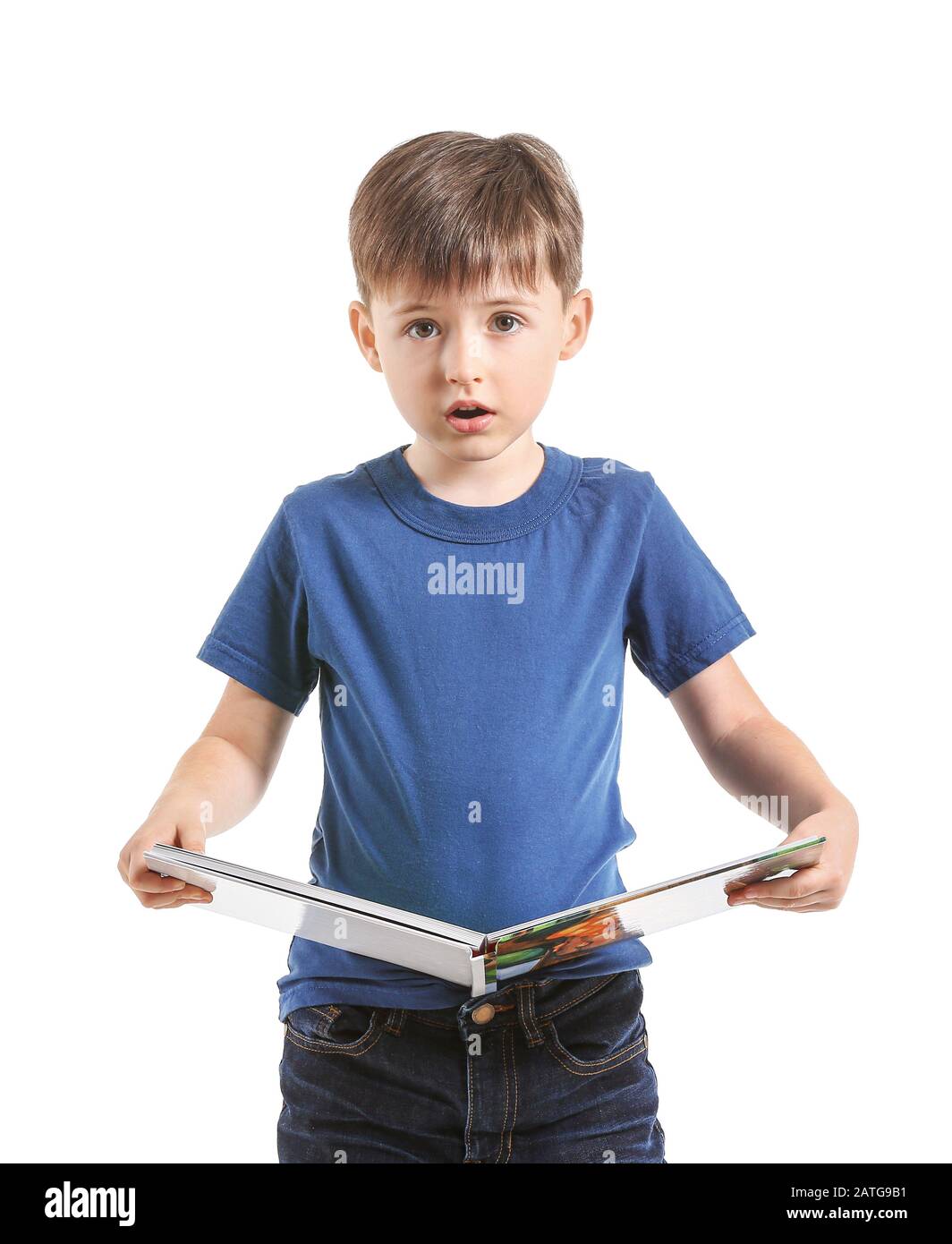 Cute little boy reading book on white background Stock Photo - Alamy