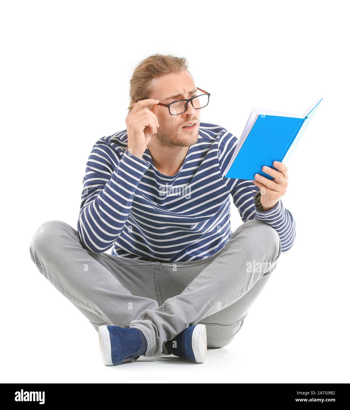 Emotional man reading book on white background Stock Photo - Alamy