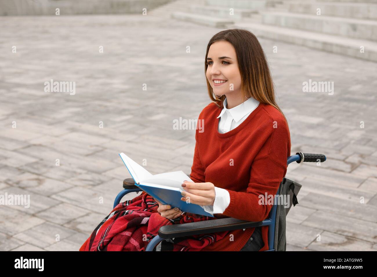 Disabled woman in wheelchair reading hi-res stock photography and ...