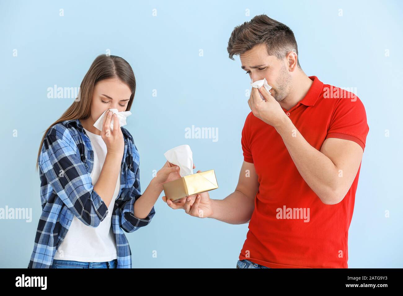 Young couple suffering from allergy on color background Stock Photo - Alamy
