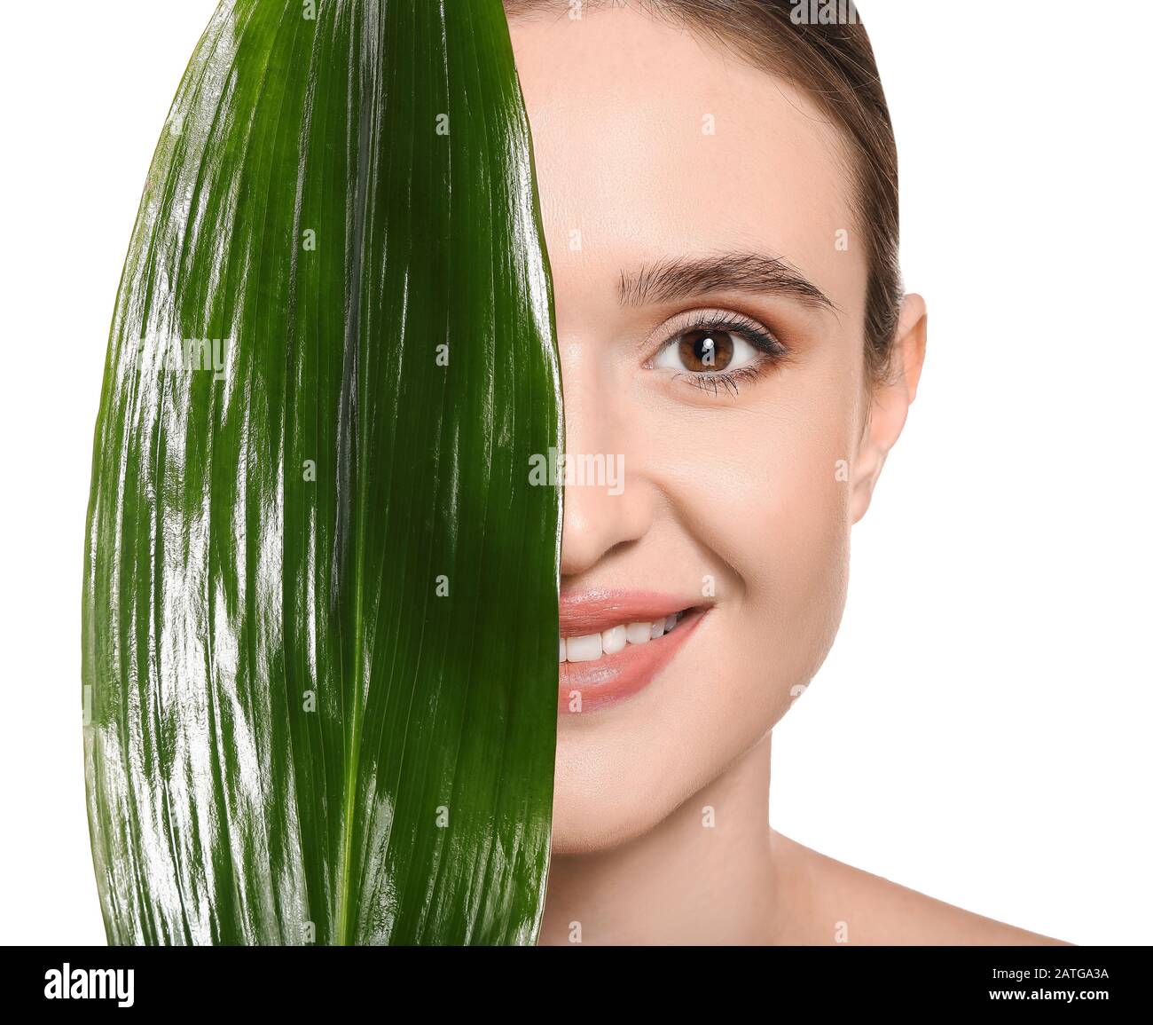 Beautiful young woman with healthy skin and tropical leaf on white ...