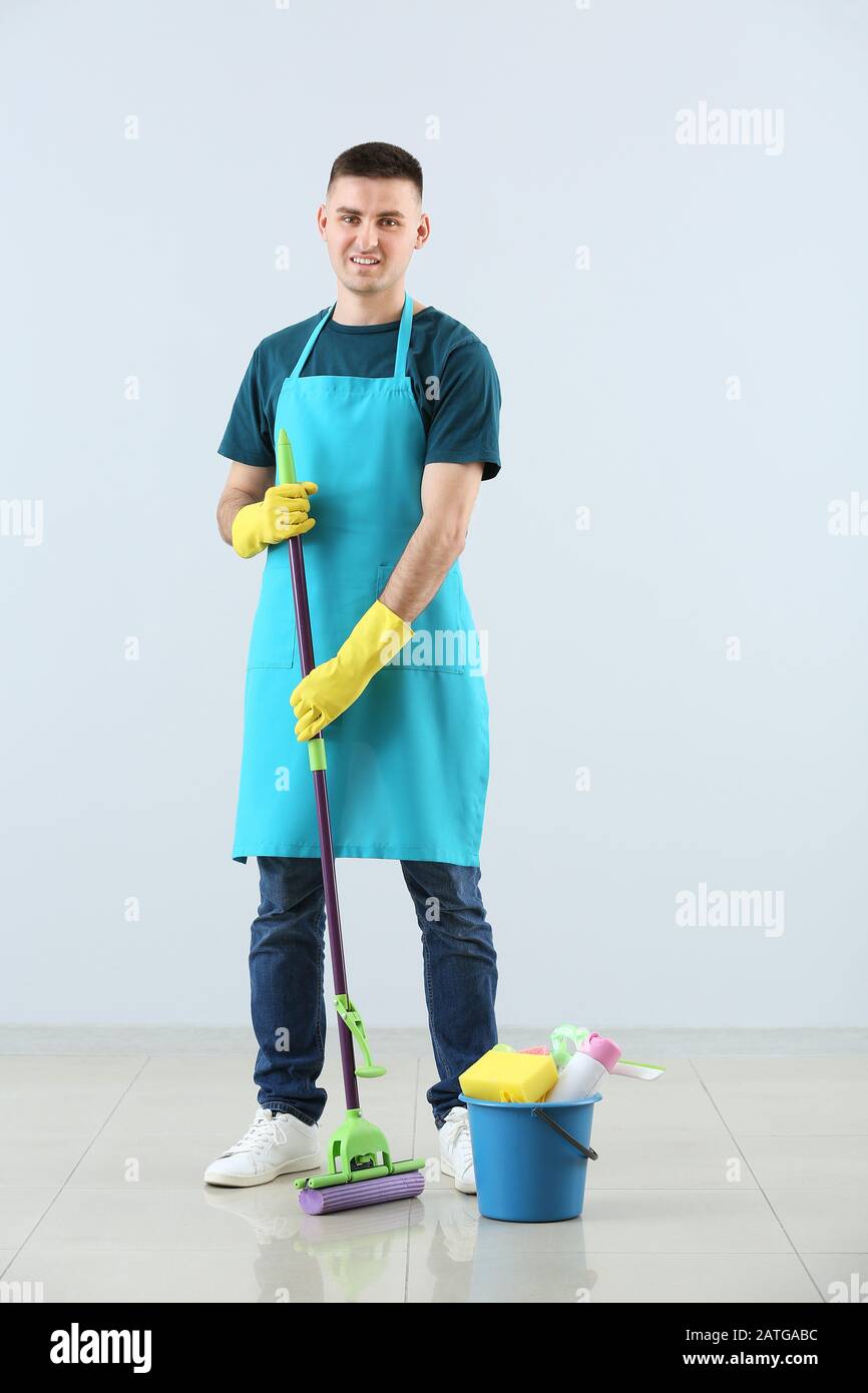 Portrait of janitor on light background Stock Photo - Alamy