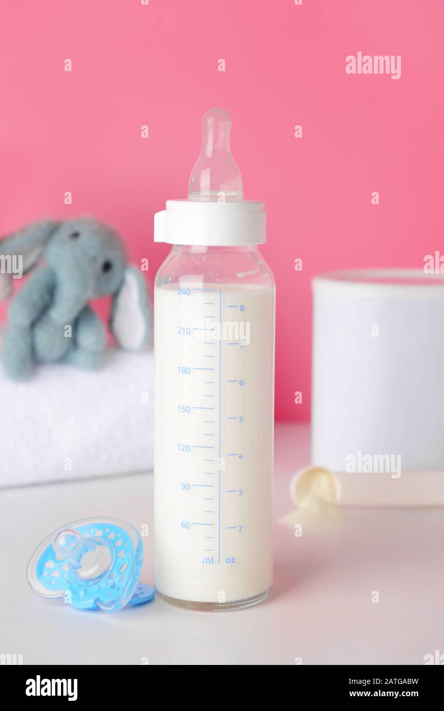 Bottle of milk for baby and pacifier on table Stock Photo - Alamy