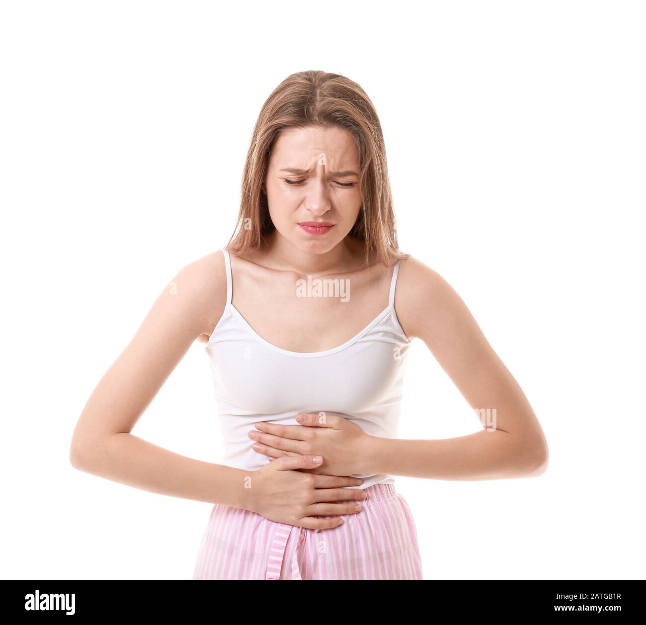 Young woman suffering from stomachache on white background Stock Photo ...