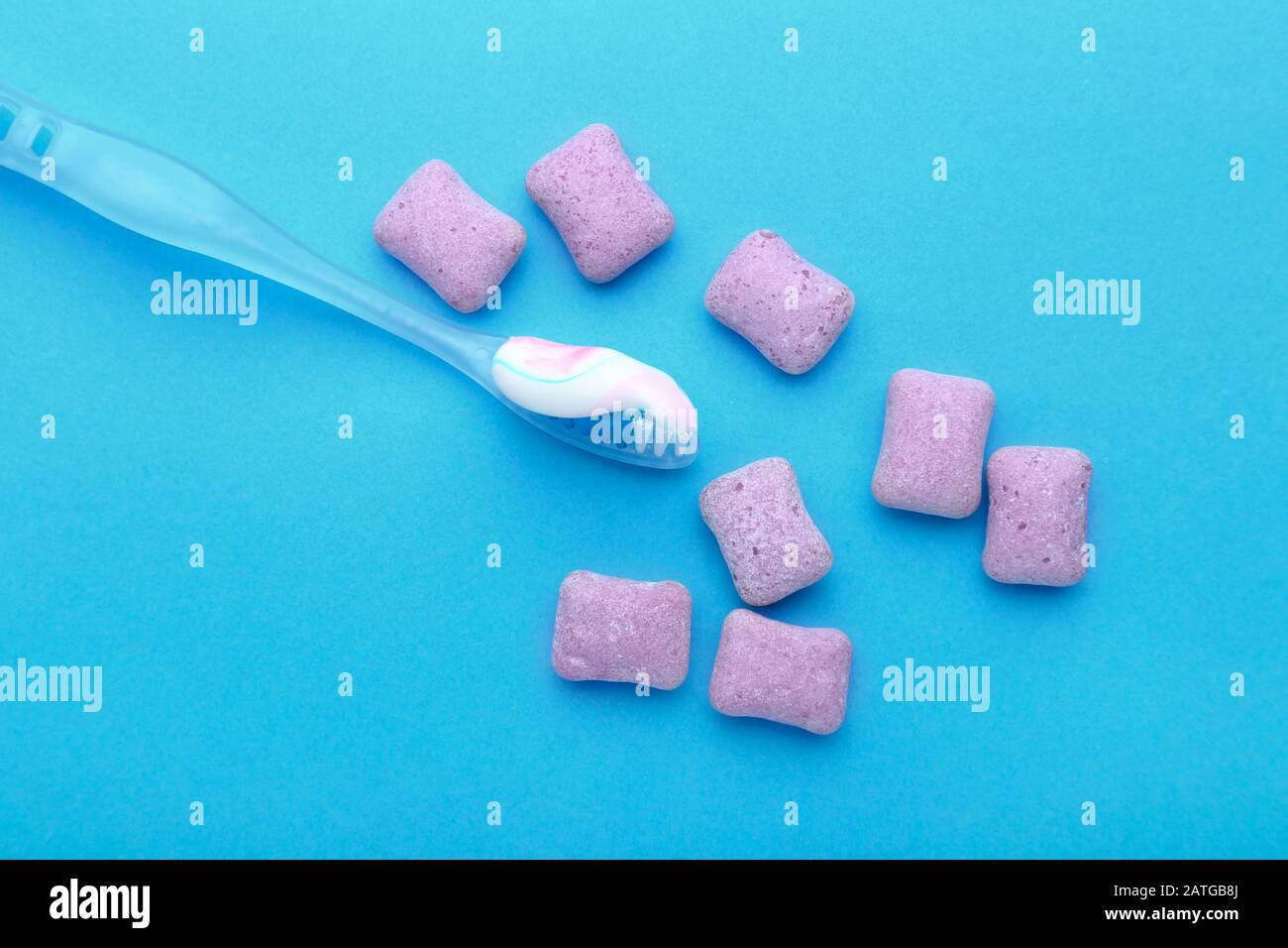 Tooth brush with paste and chewing gums on color background Stock Photo ...