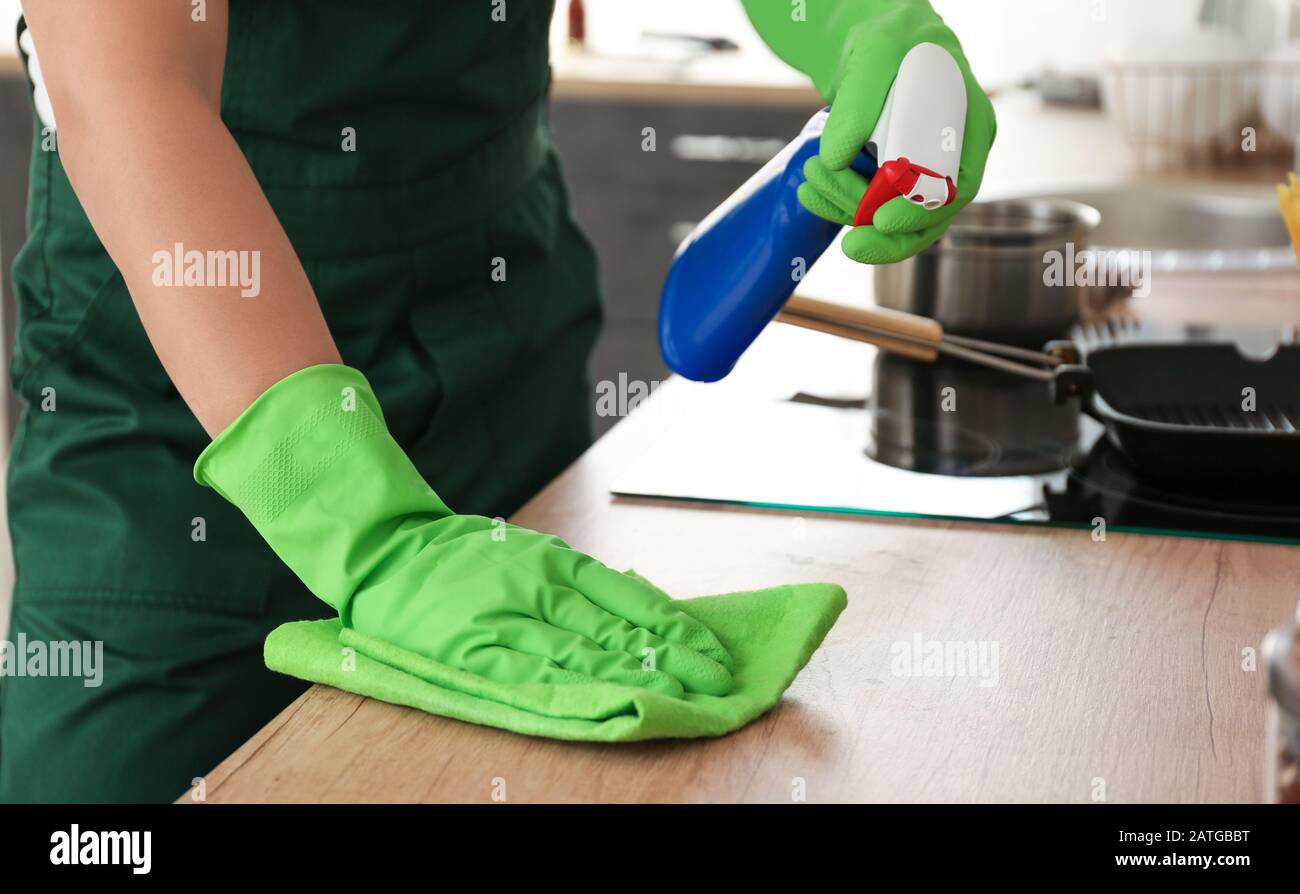 Male janitor cleaning table in kitchen Stock Photo - Alamy