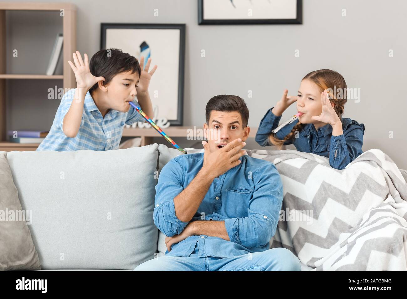 Children playing a prank on their father at home. April Fools' Day ...