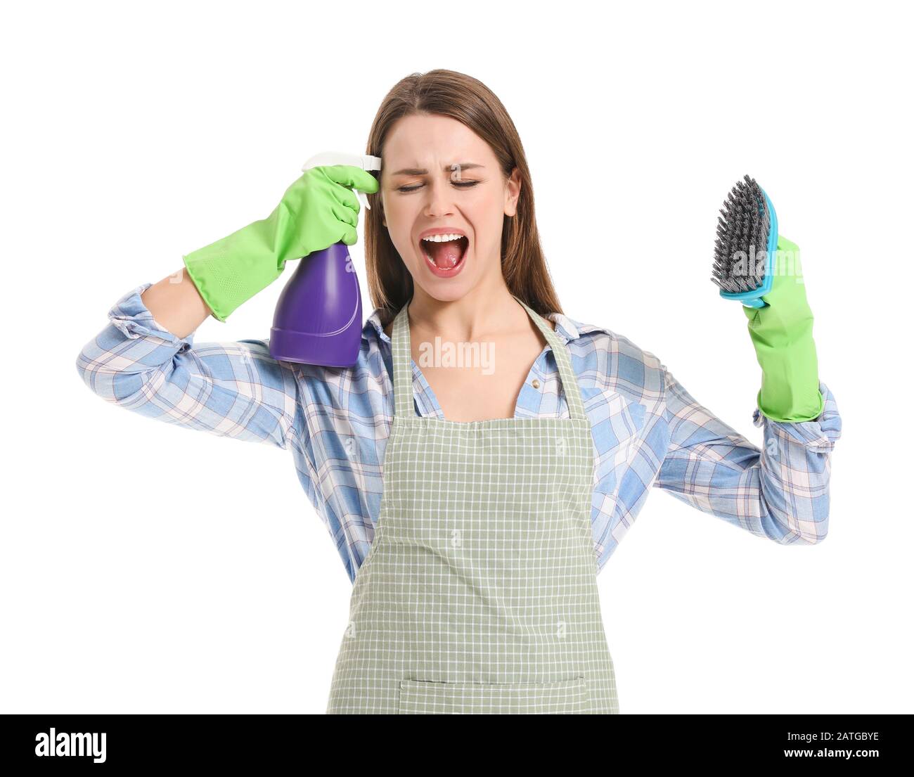 Stressed young housewife with cleaning supplies on white background ...