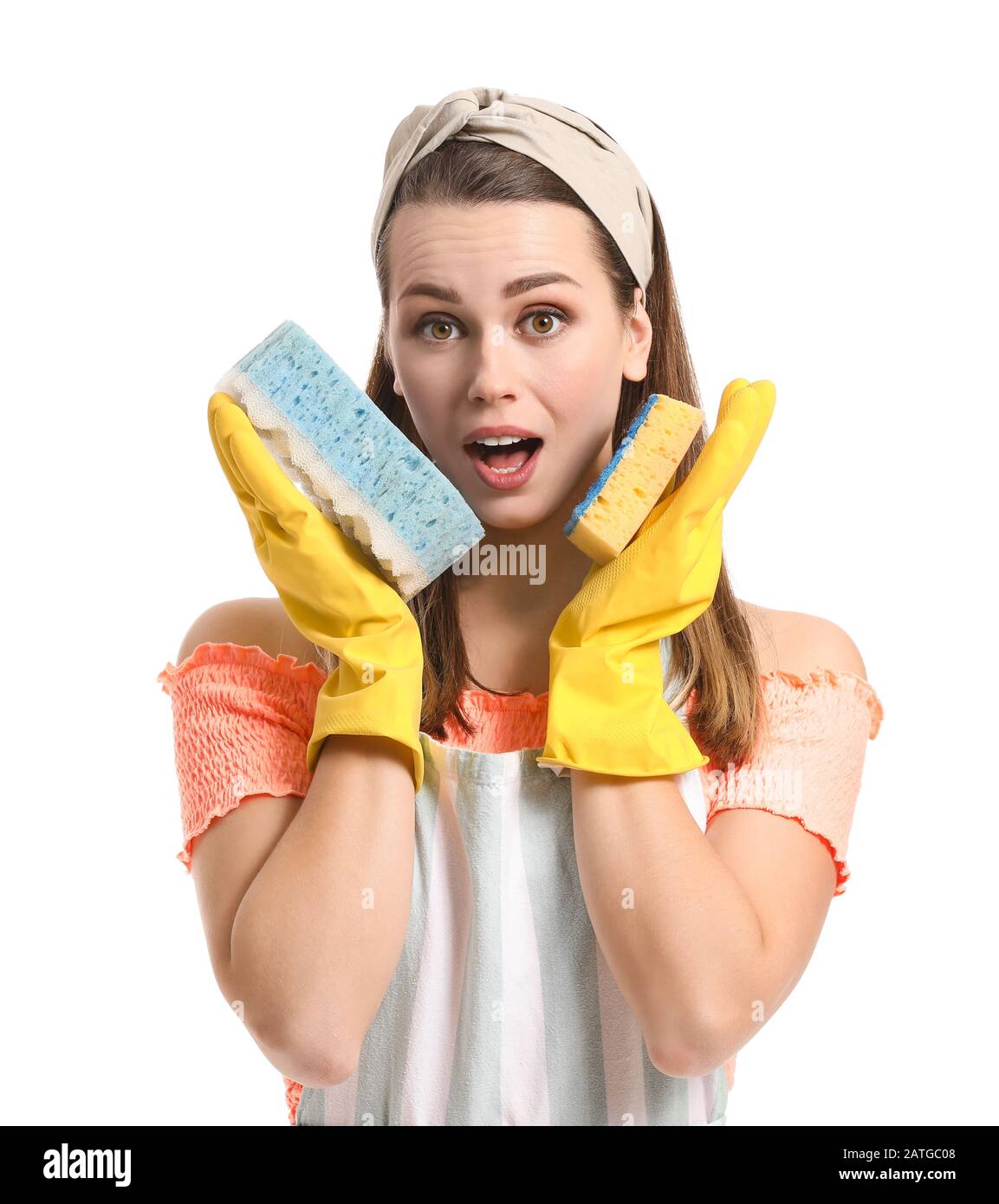 Surprised young housewife with cleaning supplies on white background ...