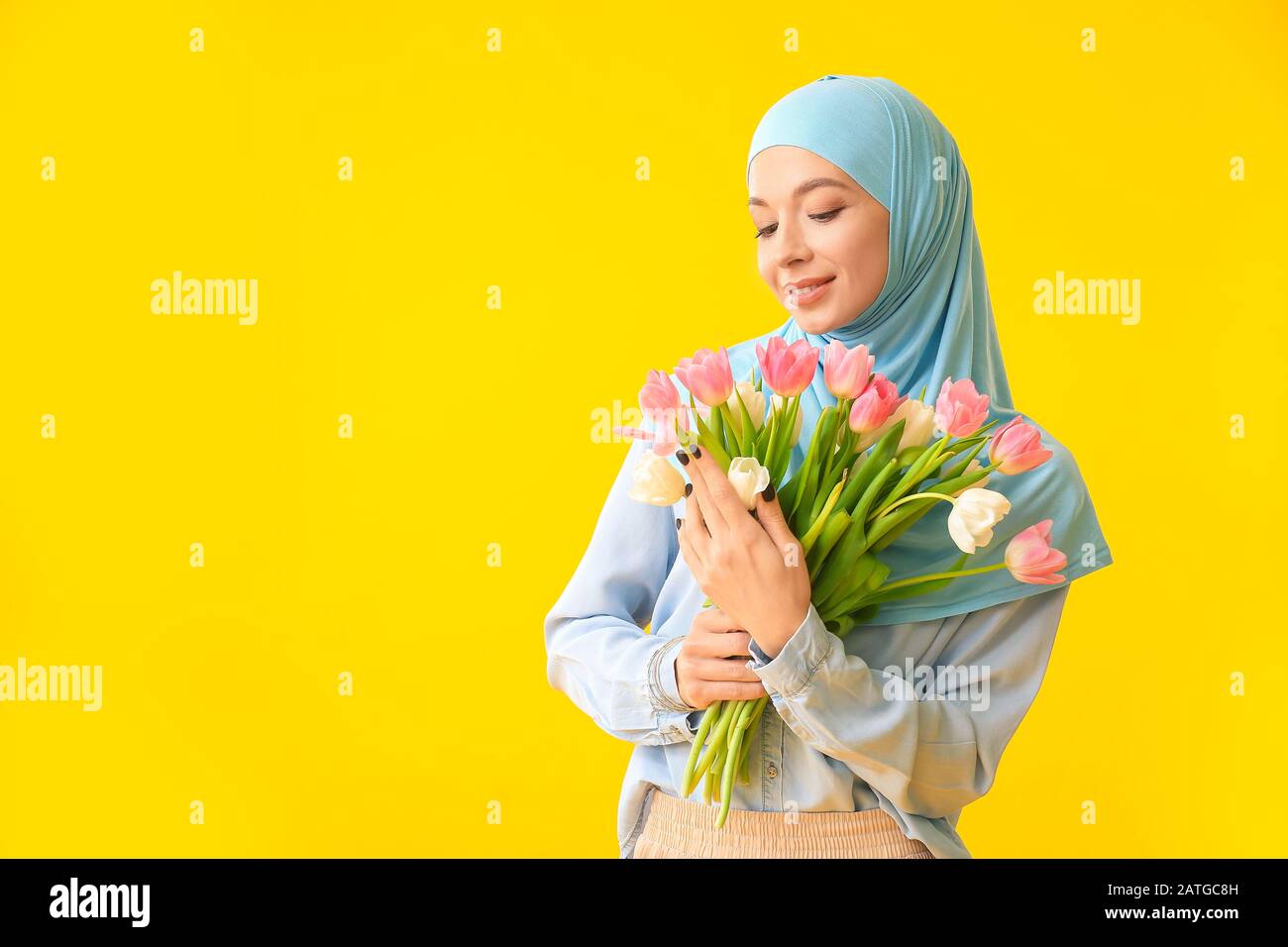 Beautiful Muslim woman with flowers on color background. International ...