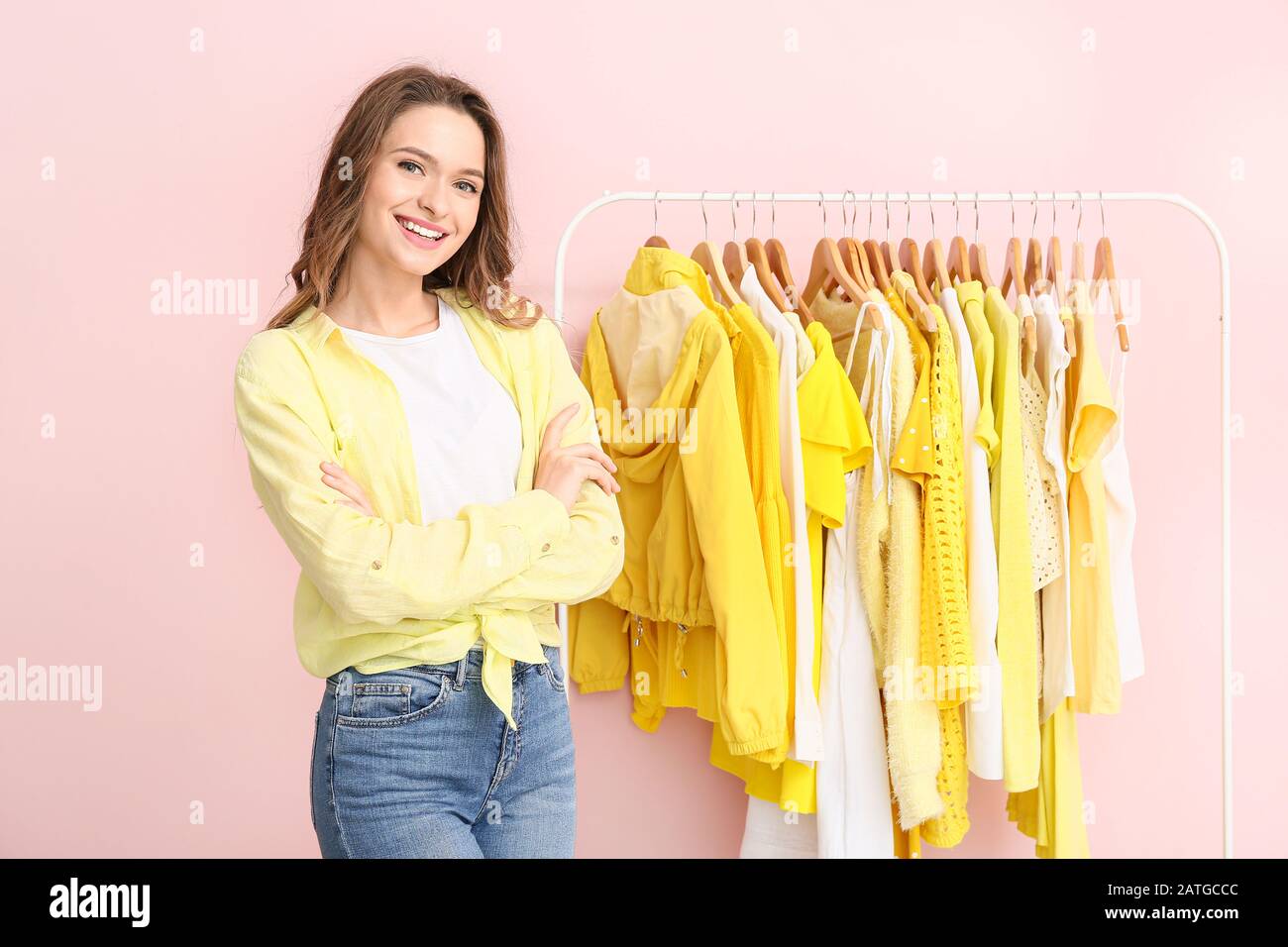 Female stylist near rack with modern clothes Stock Photo - Alamy