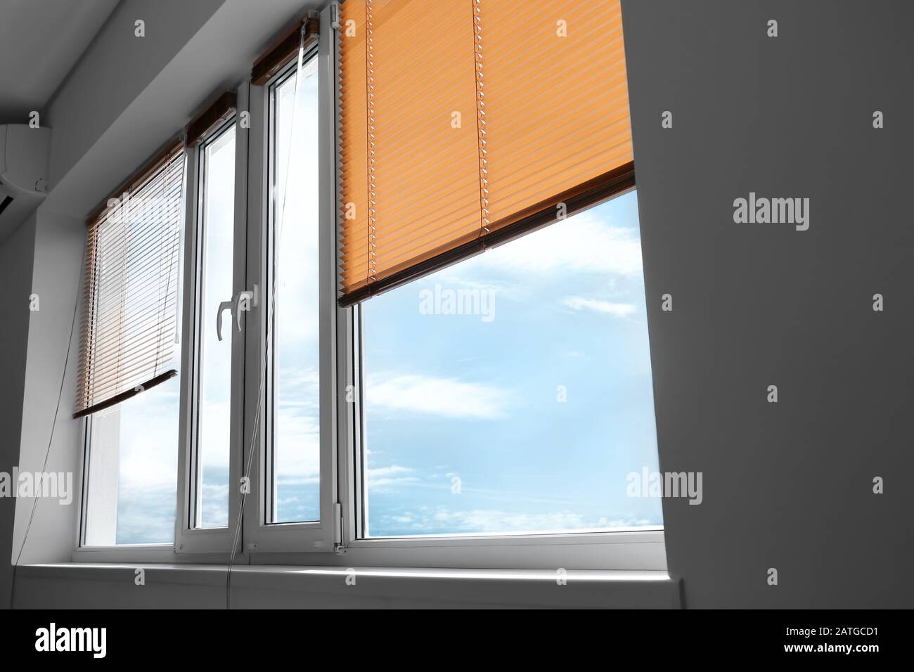 Modern blinds hanging on window Stock Photo - Alamy