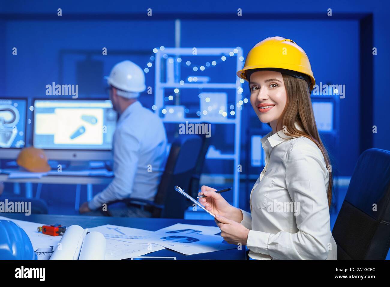 Portrait of female engineer in office at night Stock Photo - Alamy