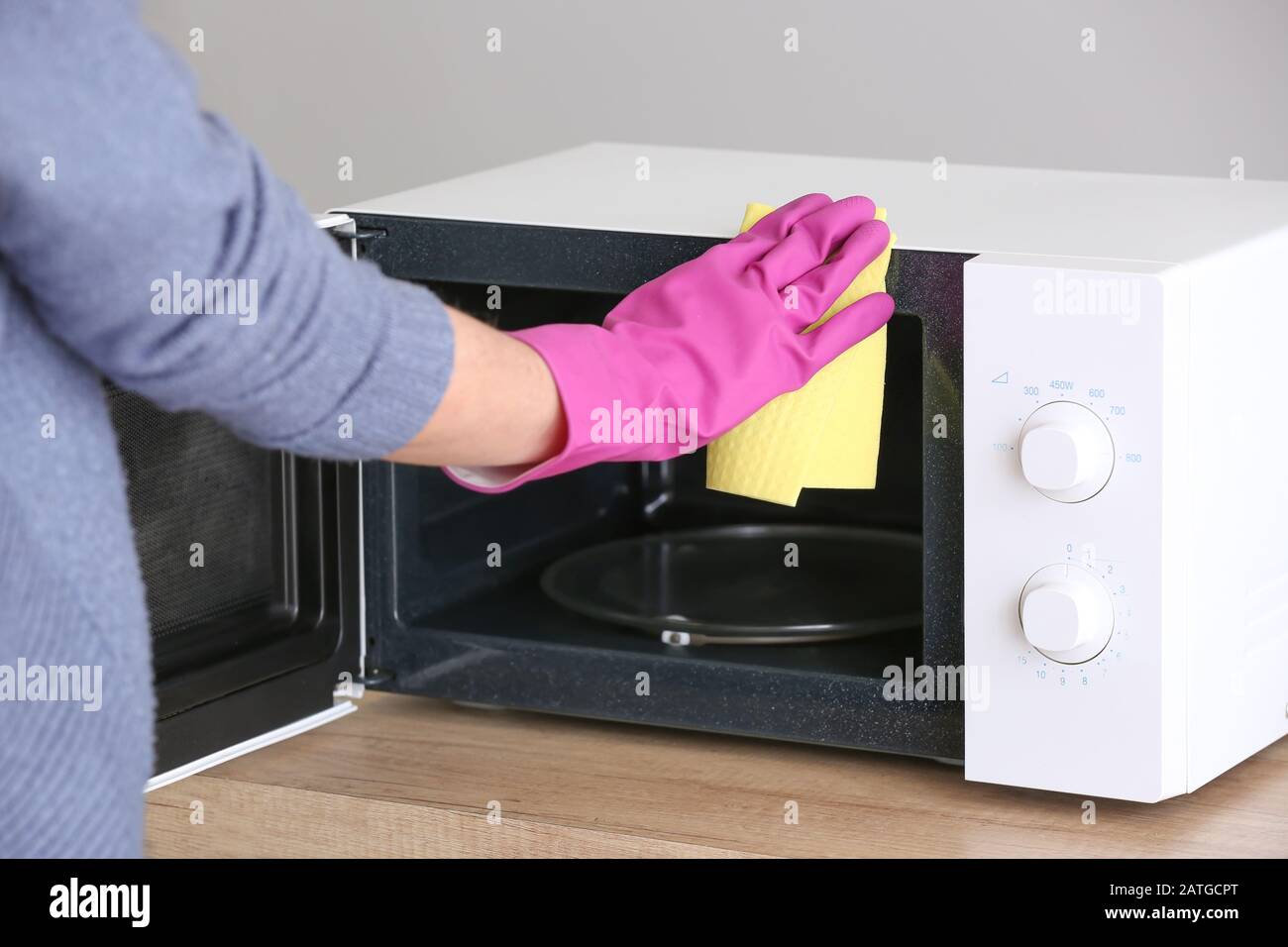Woman wiping microwave oven hi-res stock photography and images - Alamy