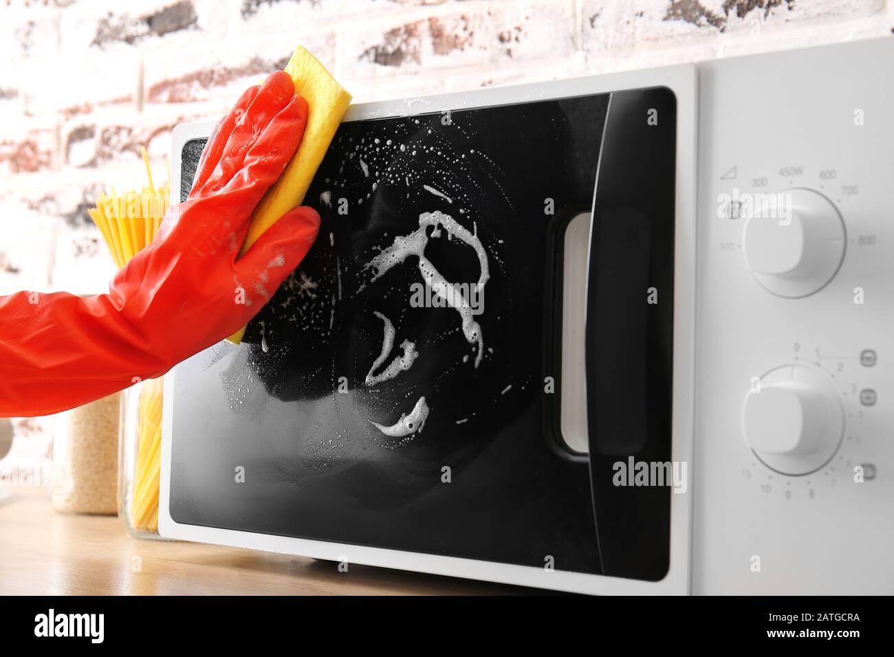 Woman wiping microwave oven hi-res stock photography and images - Alamy