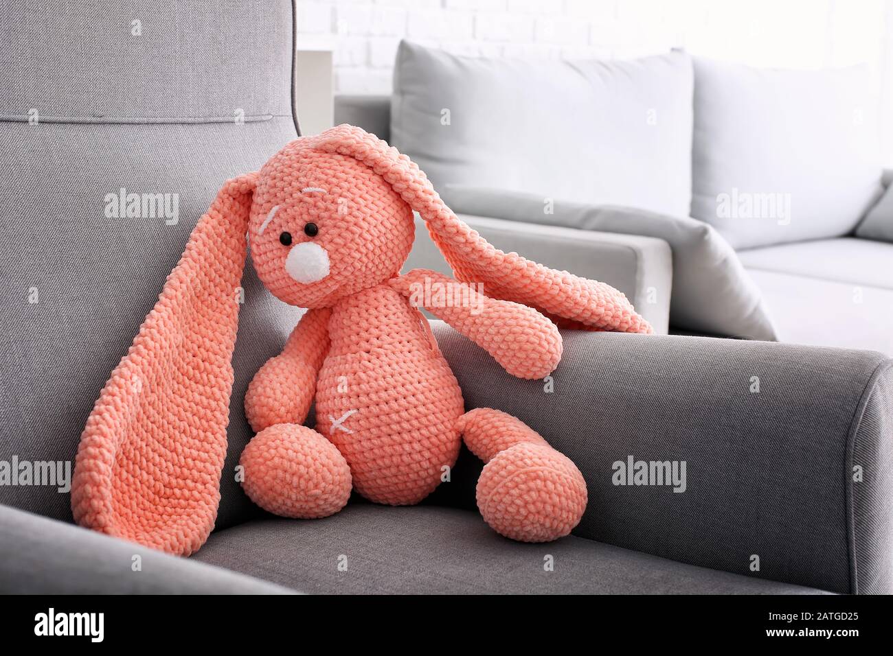 Cute baby toy on armchair Stock Photo - Alamy