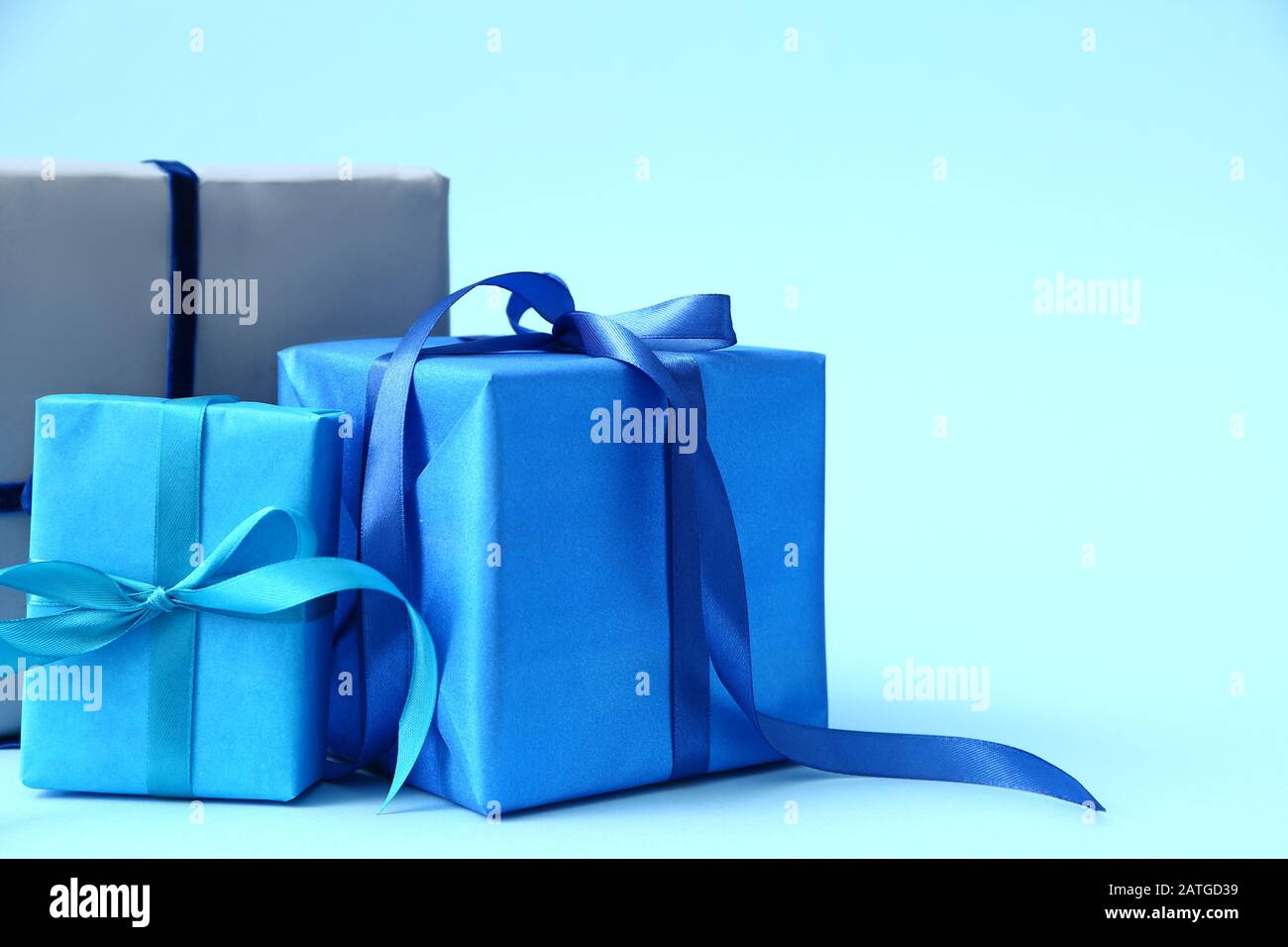 Packed gifts on color background Stock Photo - Alamy