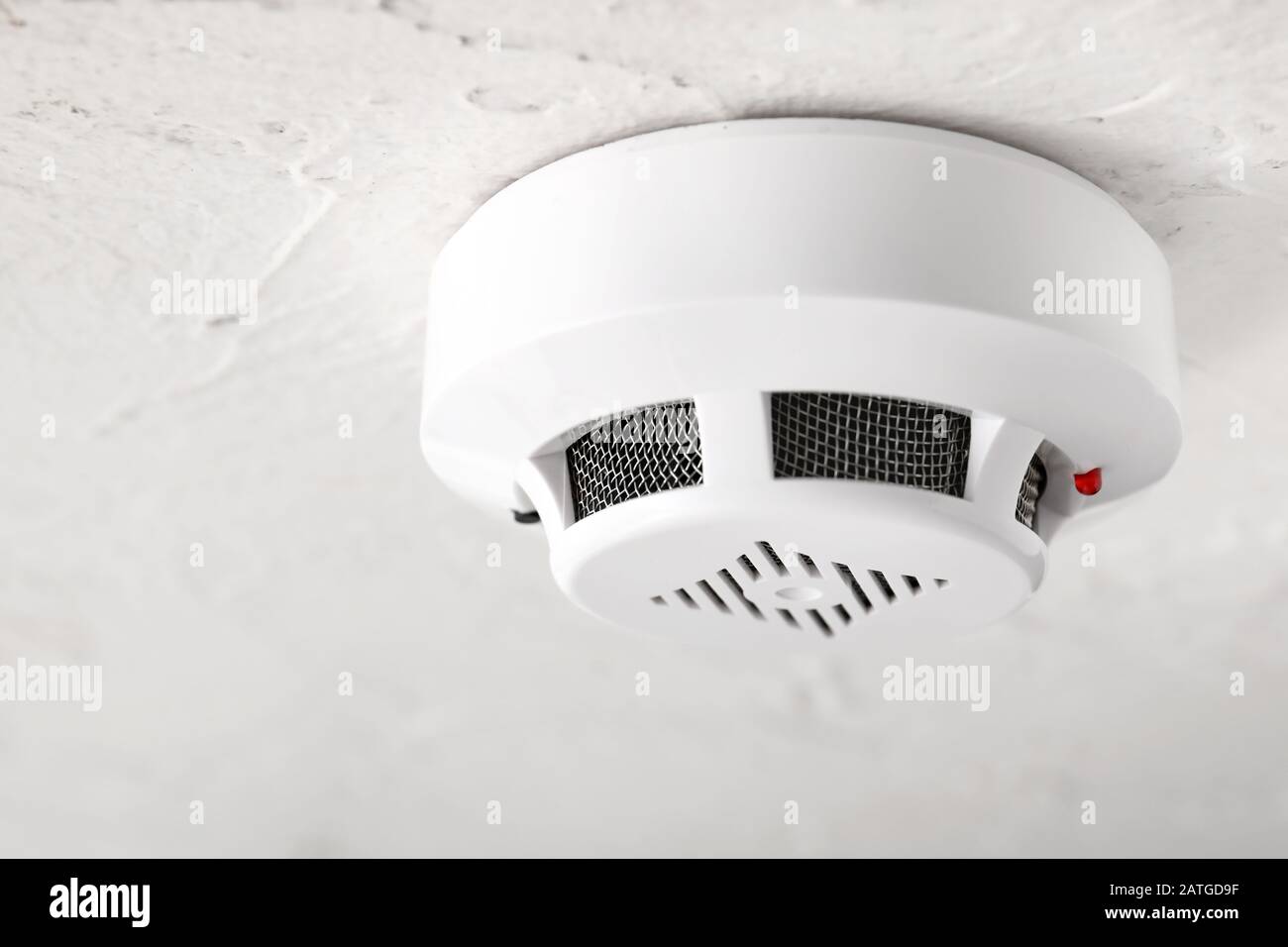 Modern smoke detector on ceiling Stock Photo - Alamy